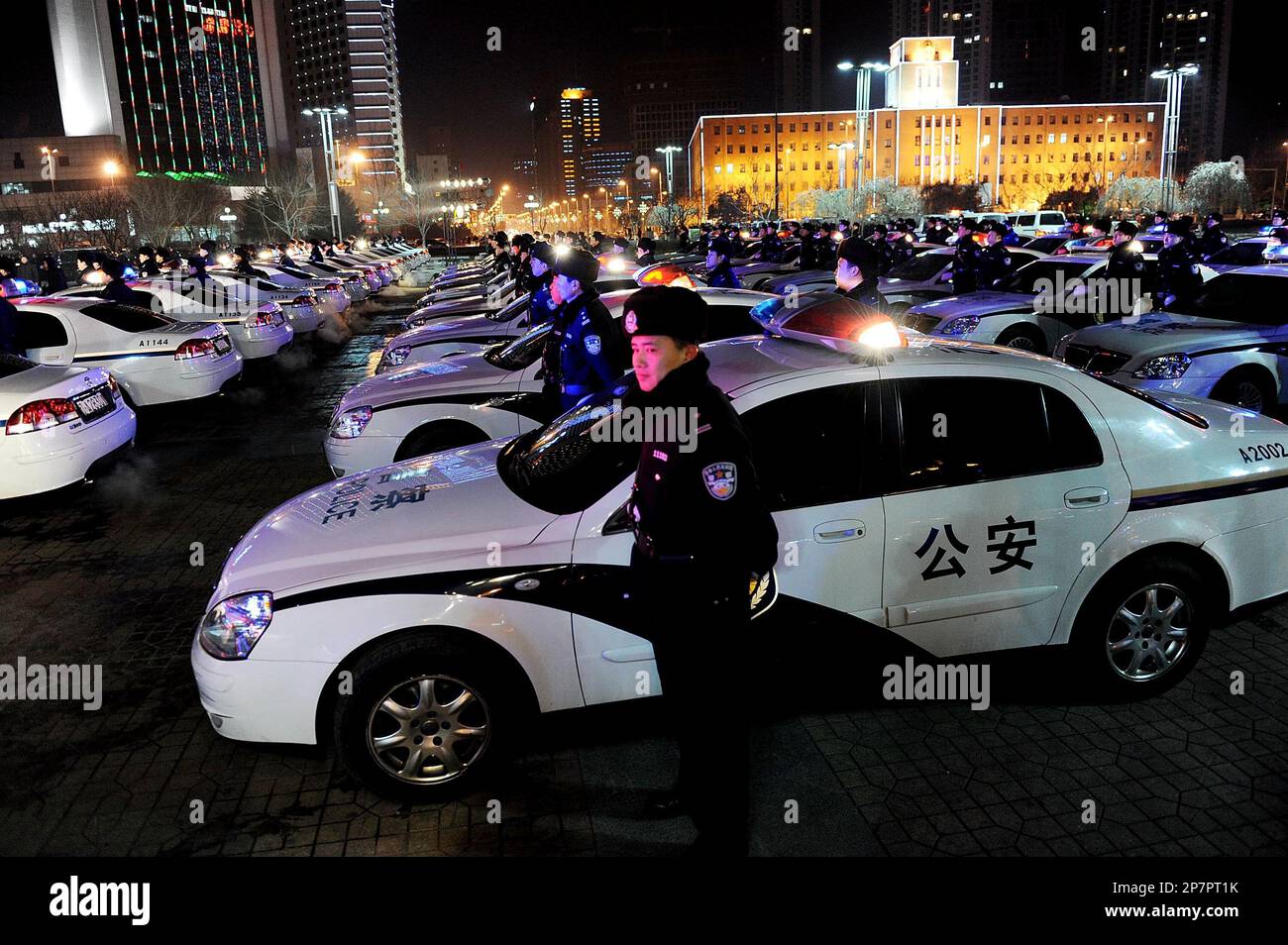 Policemen stand next to the police cars ahead of a general patrol ...