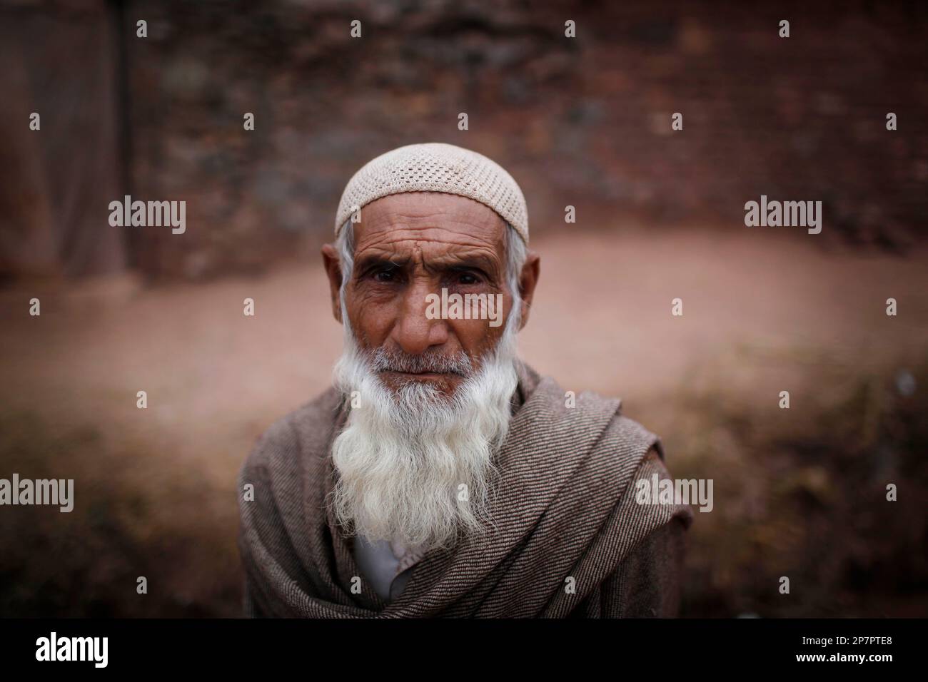 Sofi Fakar, 60, shop owner, poses for a photo in a poor neighborhood in ...