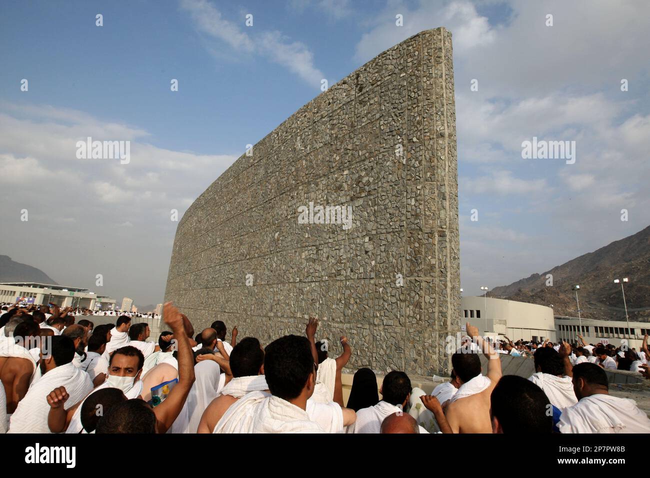 Muslim pilgrim throw pebbles at a stone pillar representing the devil ...