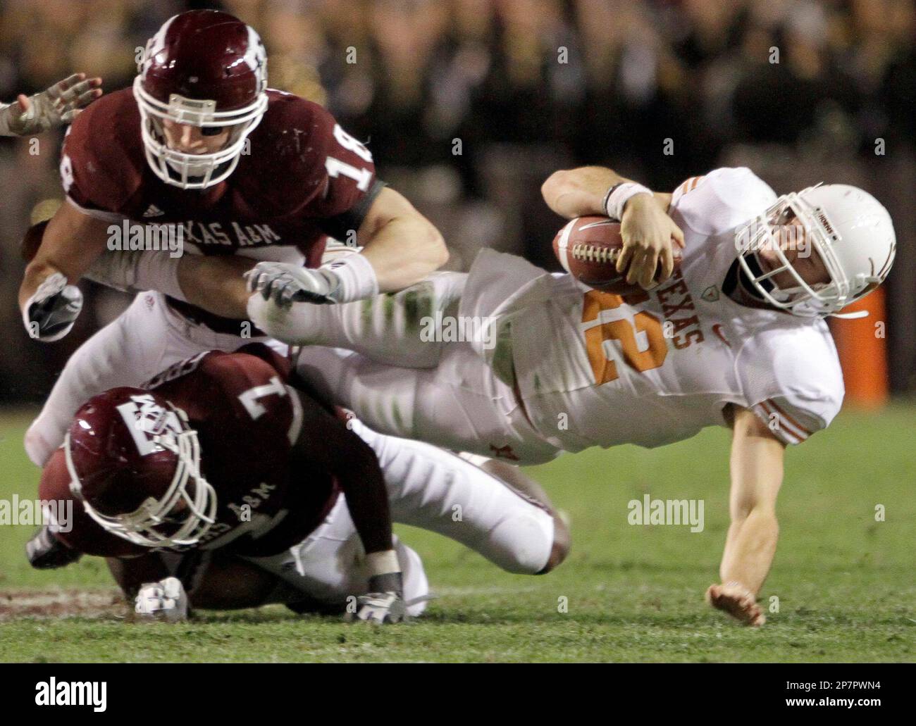 Texas quarterback Colt McCoy (12) is tackled by Texas A&M's Kyle Mangan ...