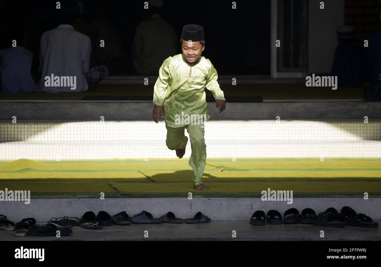 A young Muslim boy run during Eid al-Adha celebration at a mosque in ...