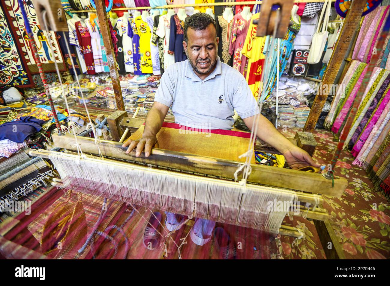 Aswan, Egypt. 8th Mar, 2023. A man weaves with a loom to make ...