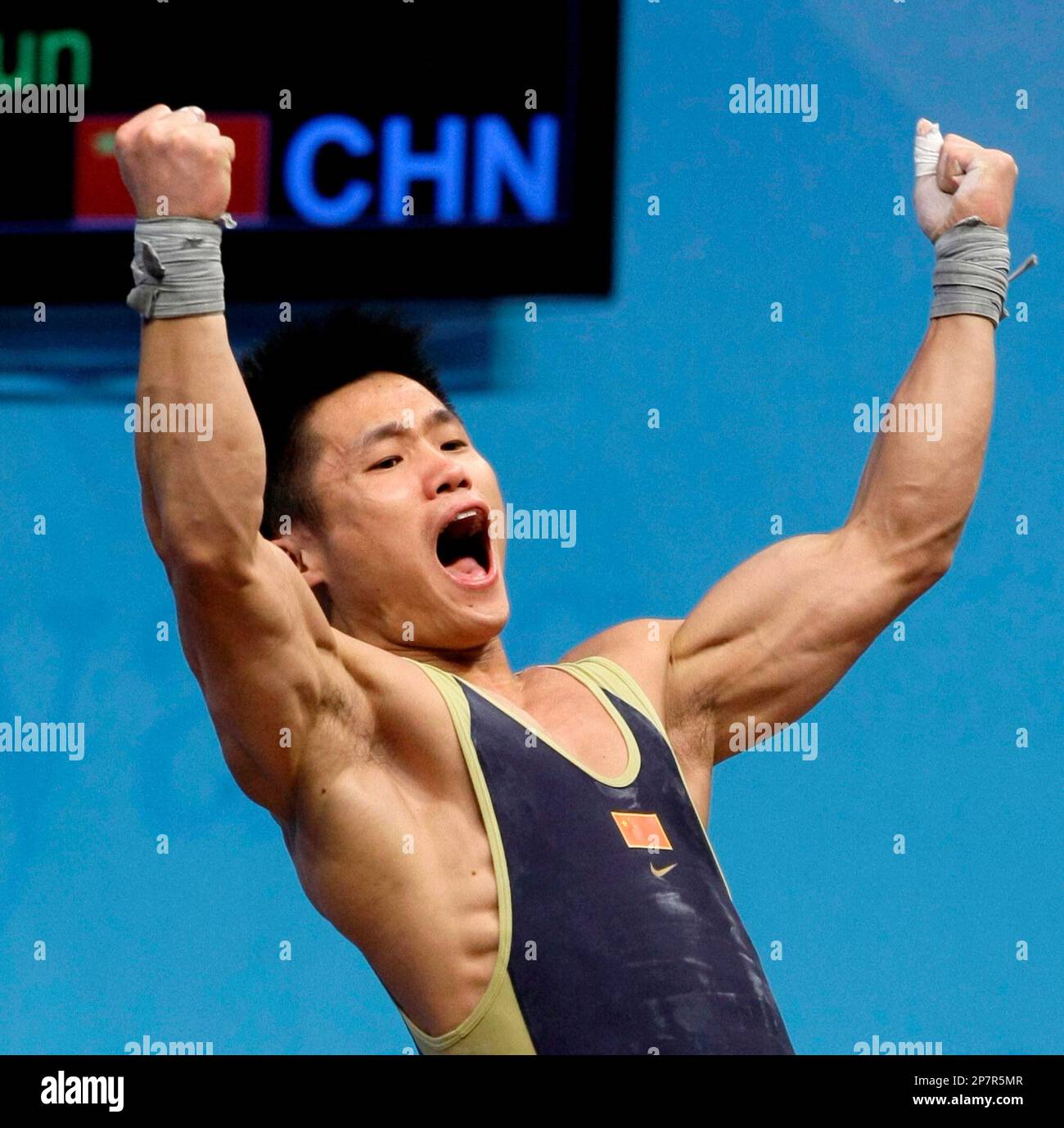 China's Lu Xiaojun reacts in the clear and jerk of the men's group A 77-kilogram category of the ...