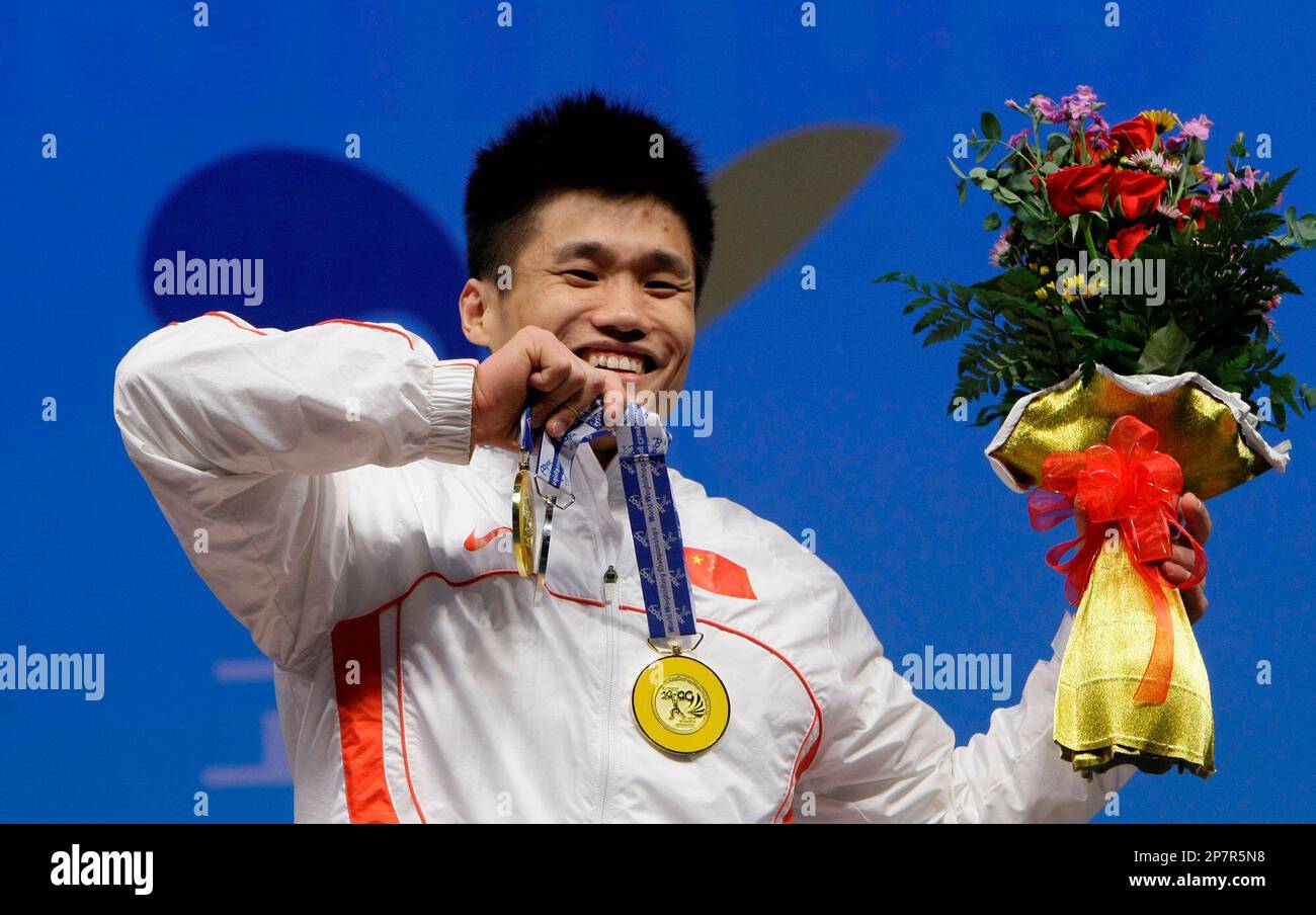 China's Lu Xiaojun shows his medals during medal ceremony of the men's ...