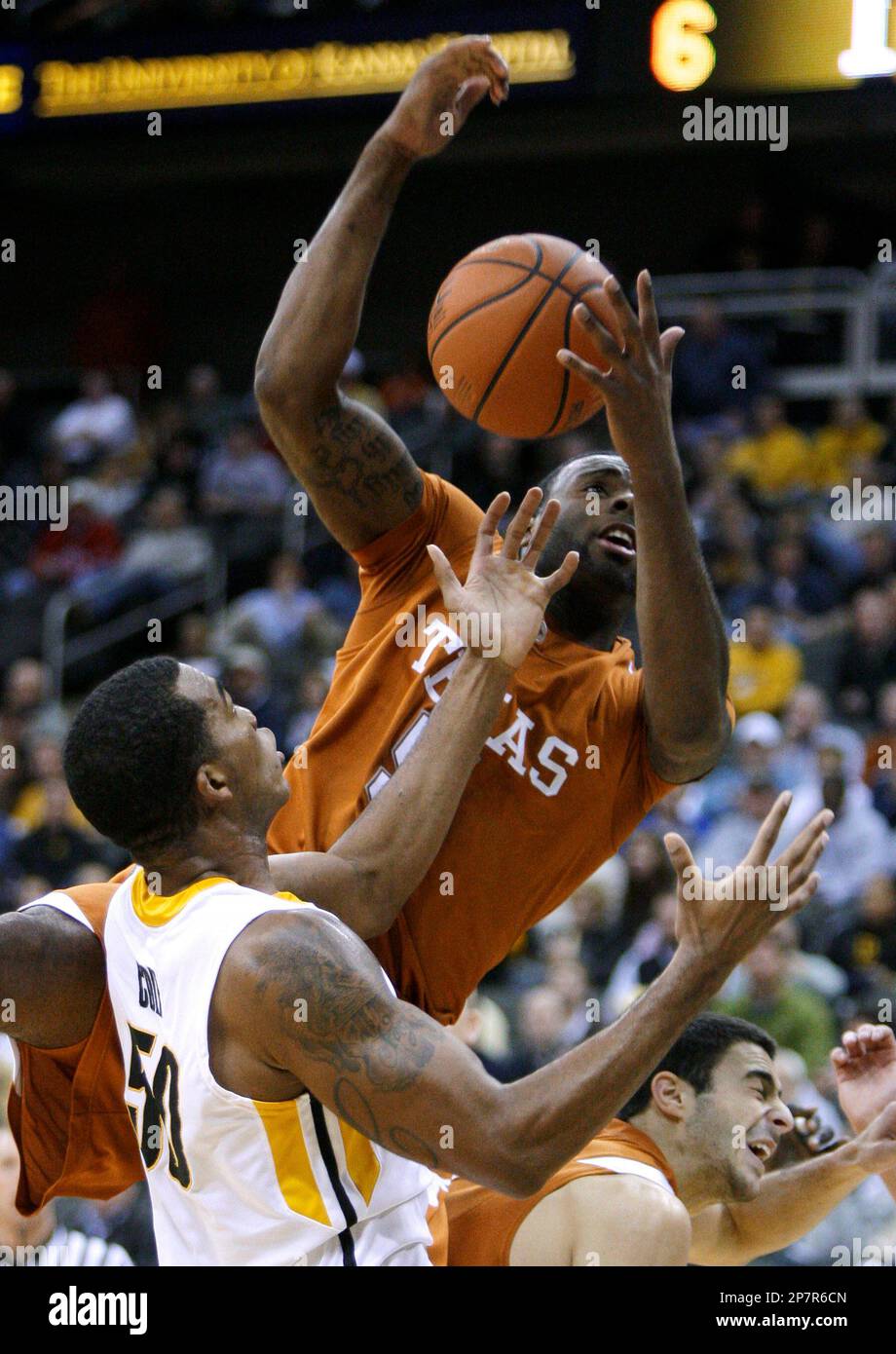 Iowa's Jarryd Cole (50) and Texas' Damion James look for a rebound ...