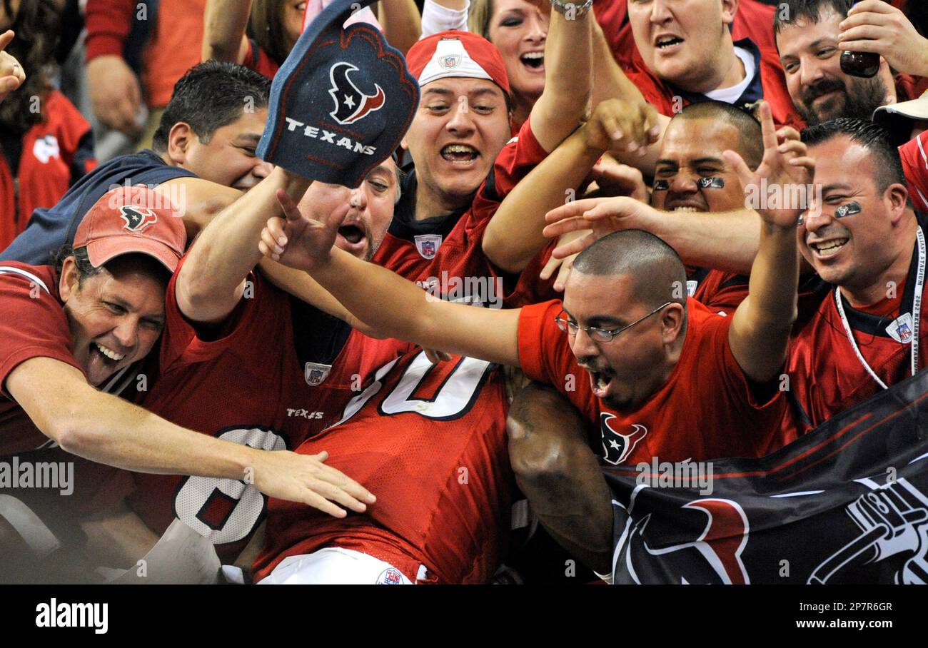 Houston Texans wide receiver Andre Johnson (80) jumps into the stands ...