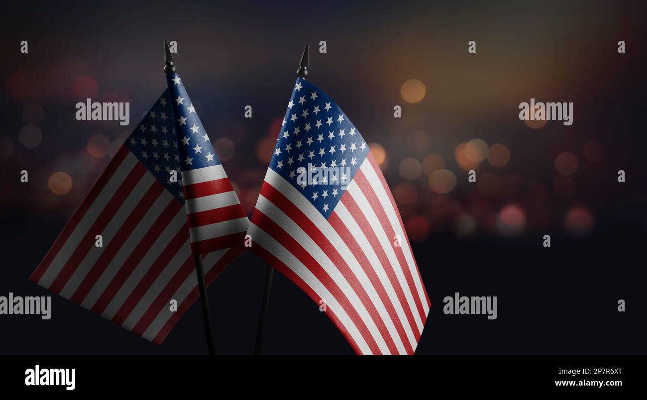 Small flags of the USA on an abstract blurry background Stock Photo - Alamy