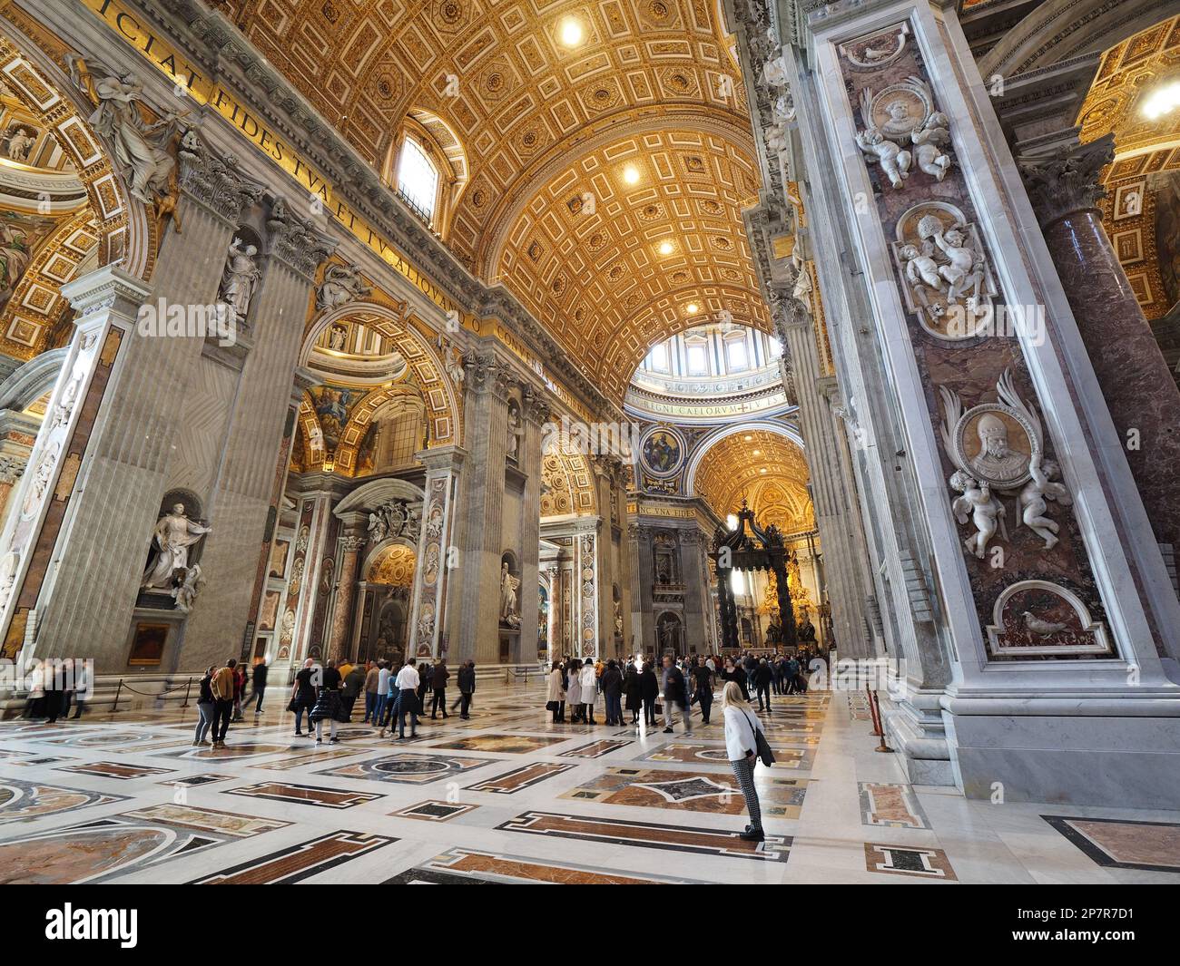 Tourists inside Saint Peters Basilica, the interior decoration and the ...