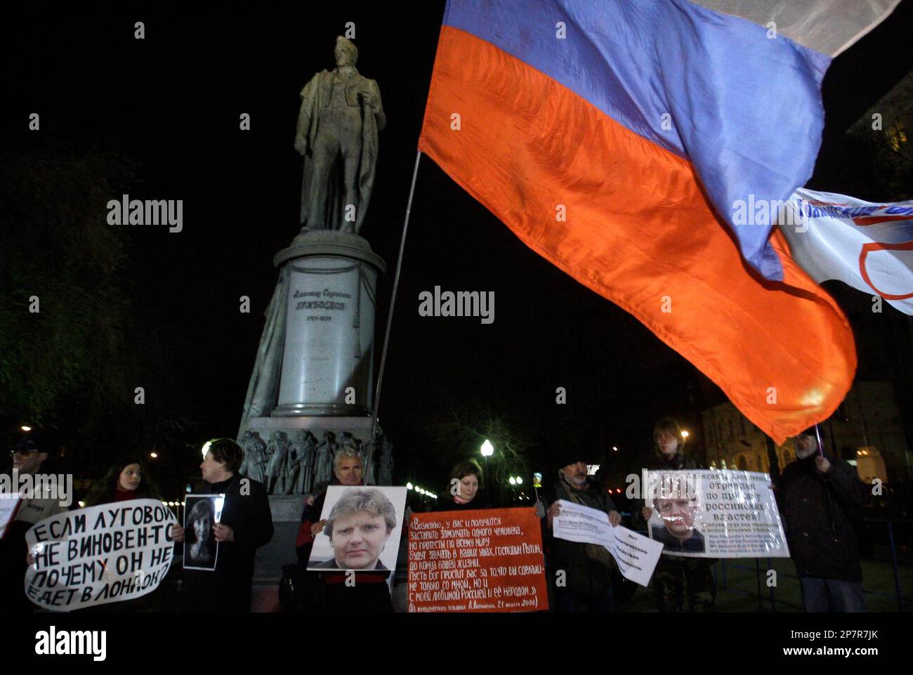 Holding posters accusing Russia's authorities and photos of poisoned ...