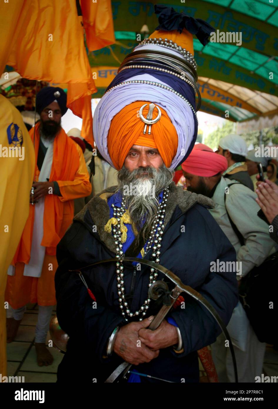A Nihang, or a Sikh warrior, with traditional headgear pays obeisance ...