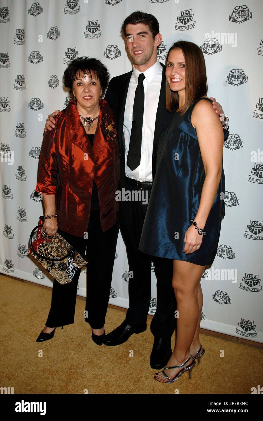 Michael Phelps, center, arrives with his mother, Debbie Phelps, left ...