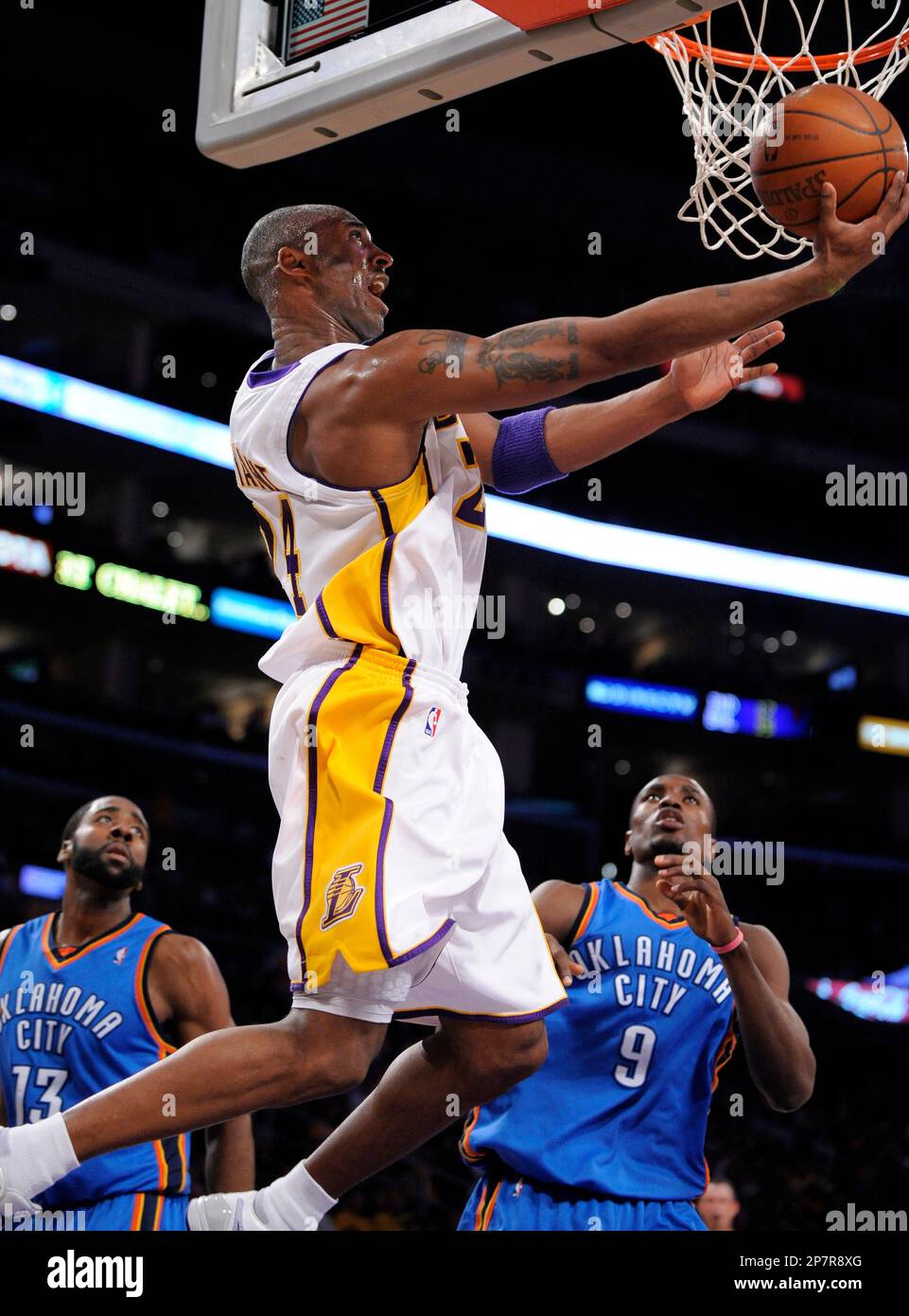 Los Angeles Lakers guard Kobe Bryant, center, puts up a shot as ...