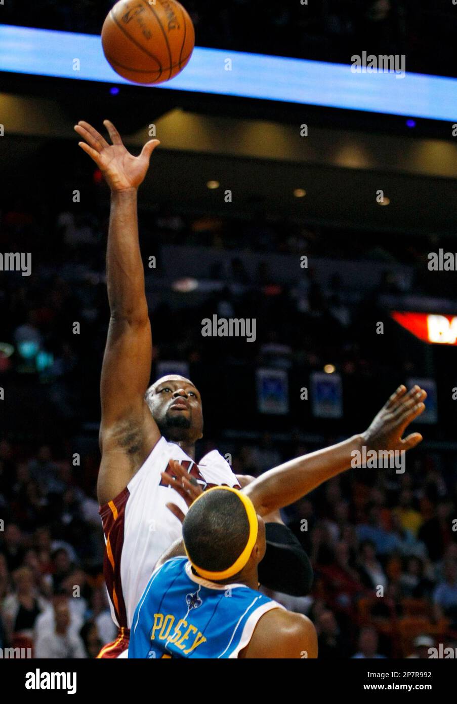 Miami Heat's Dwyane Wade shoots over New Orleans Hornets' James Posey ...