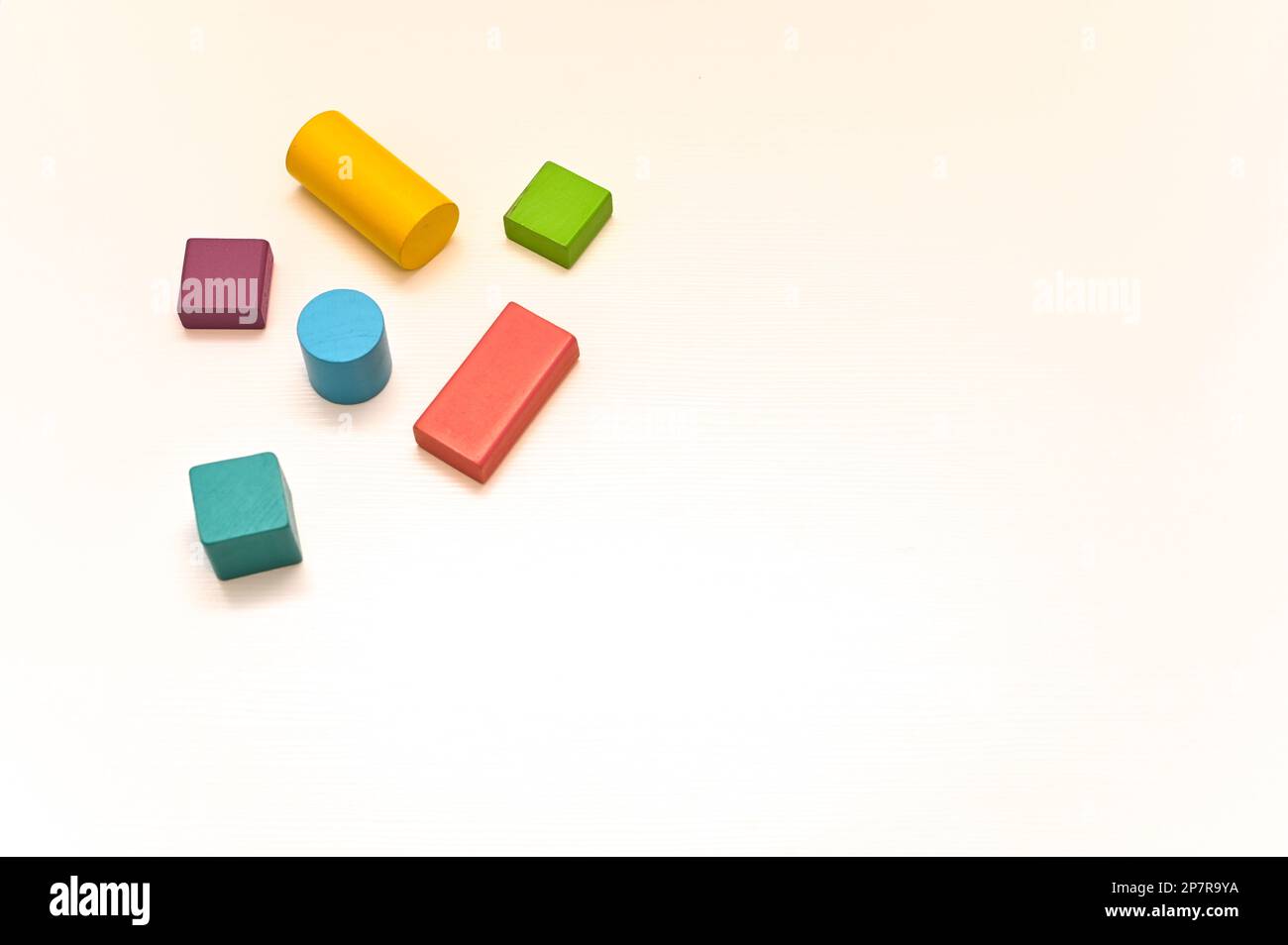 Multicolored wooden figures of different shapes. development of ...