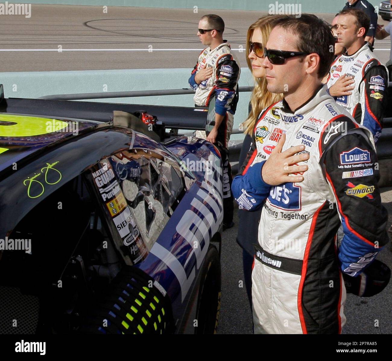 Jimmie Johnson, right front, stands with his wife Chandra, back, during ...