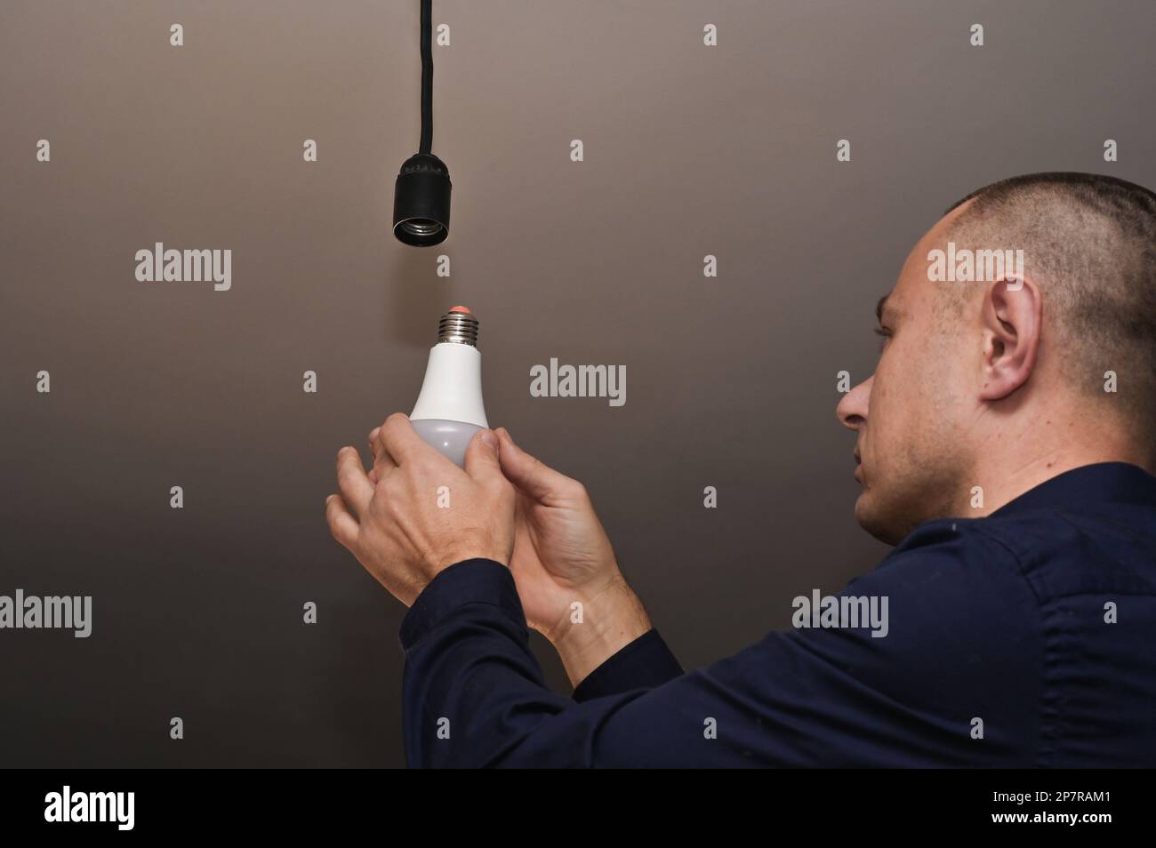 Man changes light bulb hi-res stock photography and images - Alamy