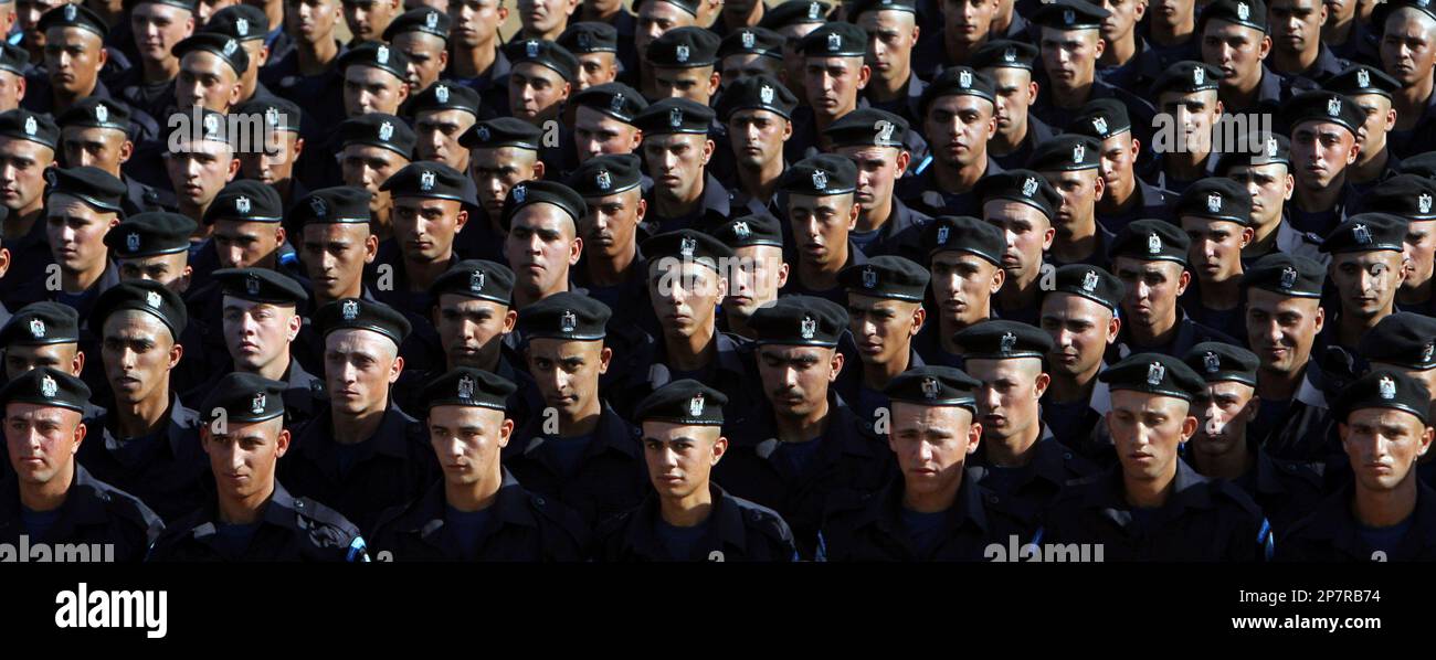 Palestinian police officers participate in a graduation ceremony of a ...