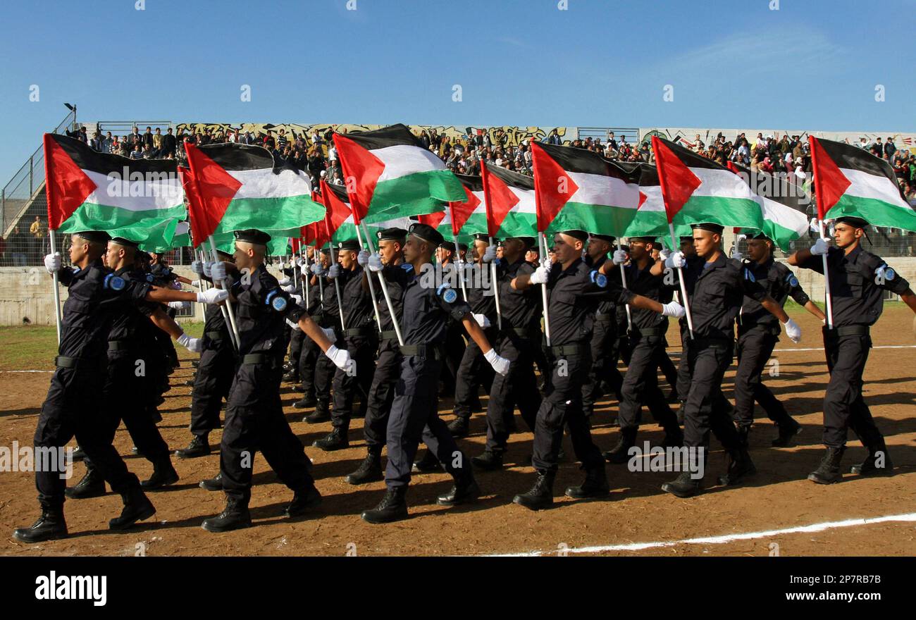 Palestinian police officers participate in the graduation ceremony of a ...