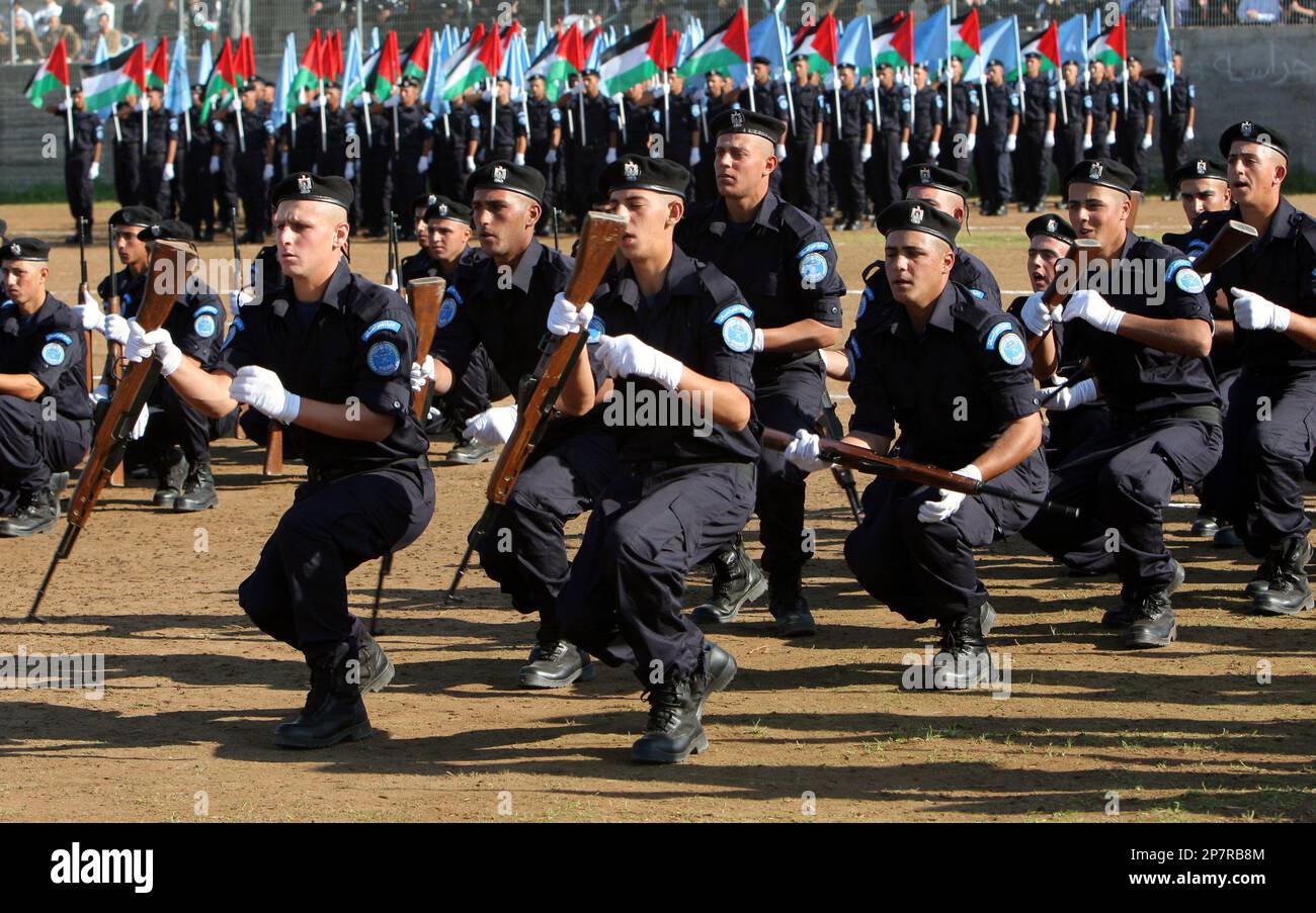 Palestinian police officers participate in a graduation ceremony of a ...