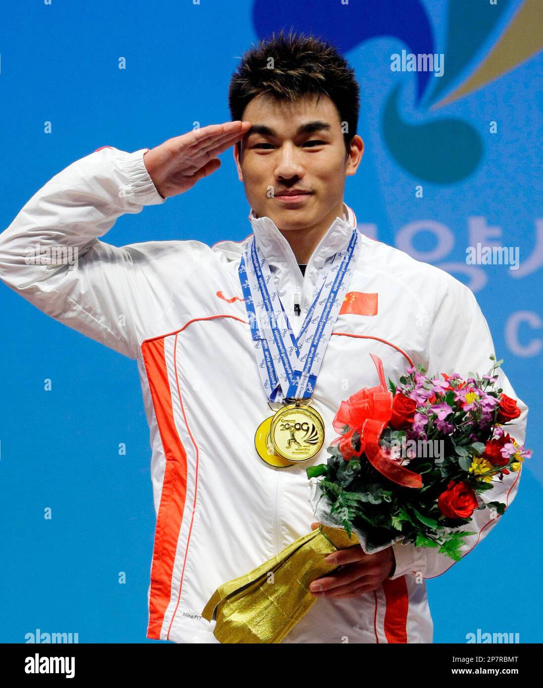 China's Liao Hui salutes during his medal ceremony for the men's group ...