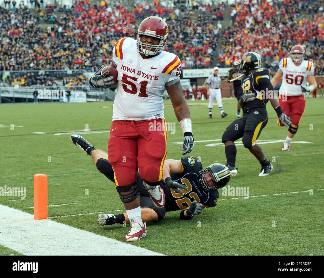 Iowa State offensive lineman Scott Haughton, top, scores past Missouri ...