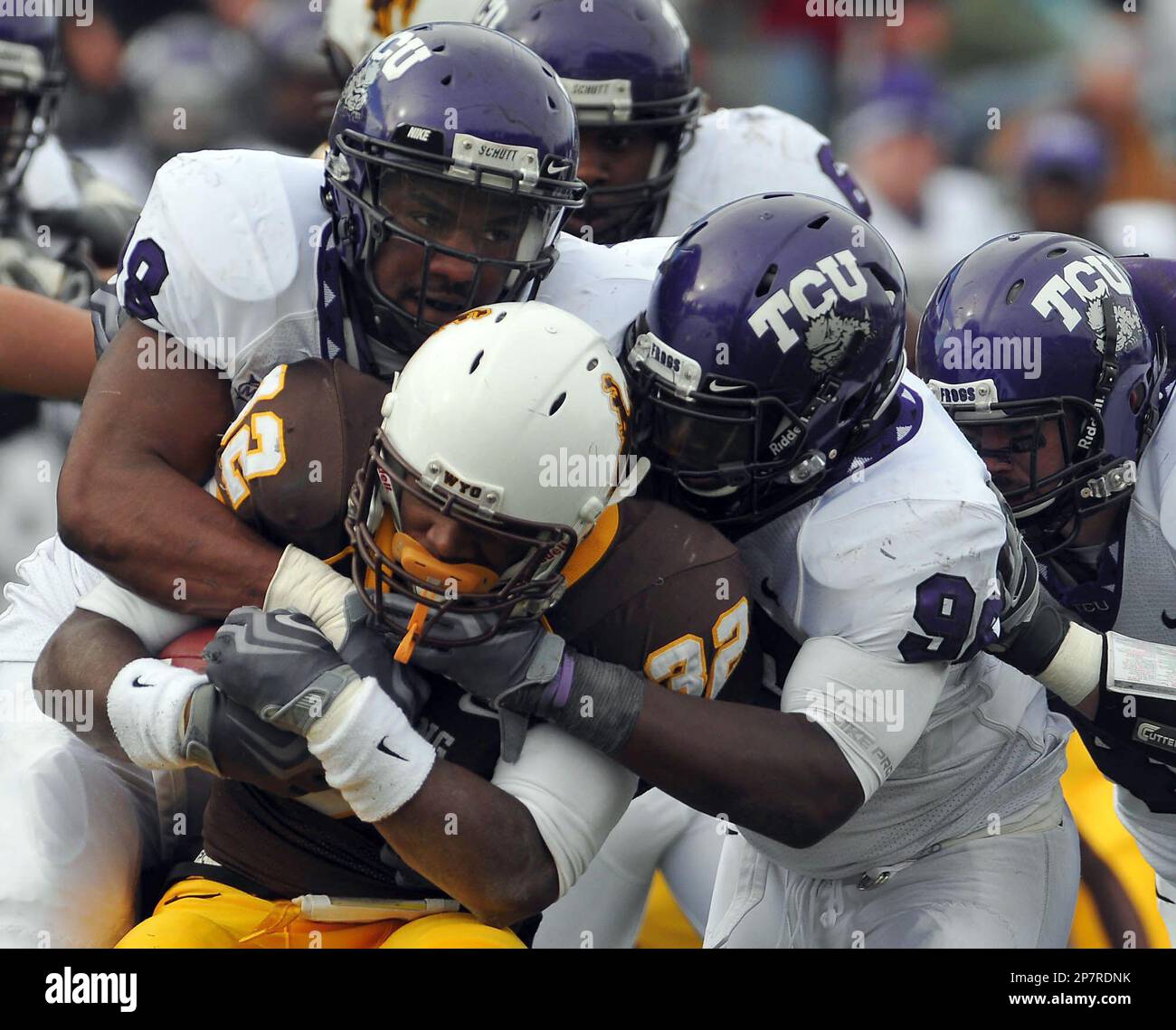 TCU defensive ends Jerry Hughes, left, and Wayne Daniels, right, tackle ...