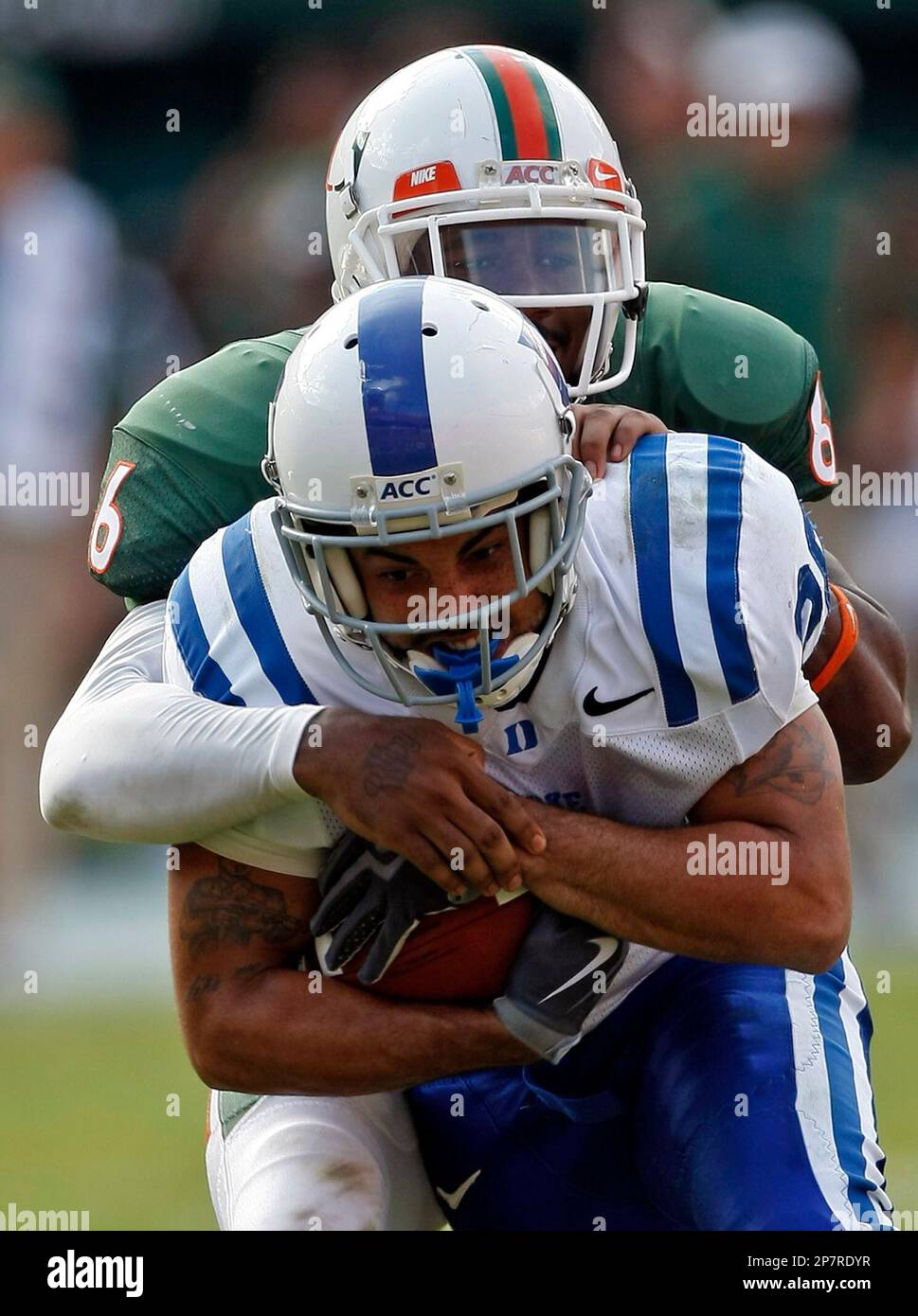 Duke wide receiver Donovan Varner, foreground, is tackled by Miami ...