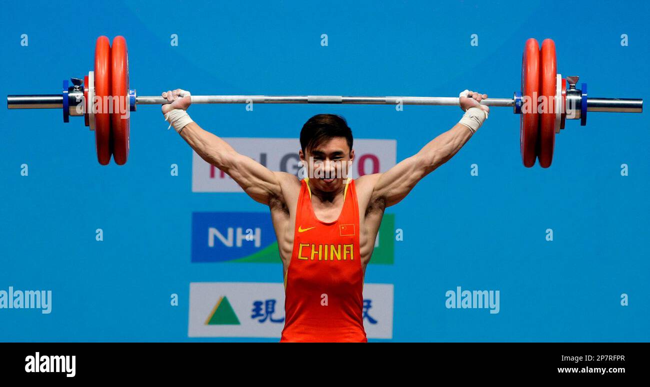 Yang Fan of China strains in the clean and jerk during the 77th men's ...