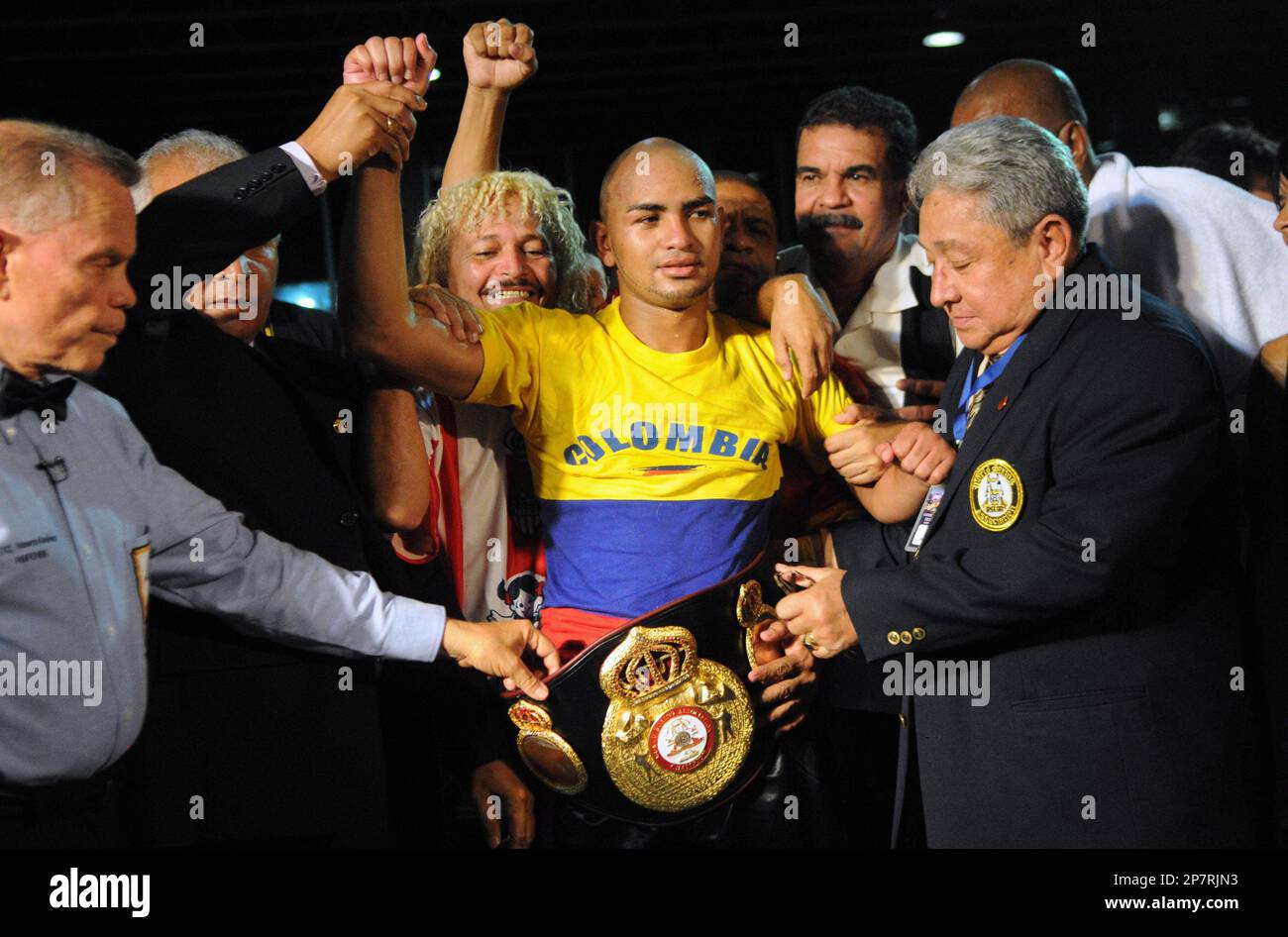 Likar Ramos, of Colombia, receives the championship belt after ...