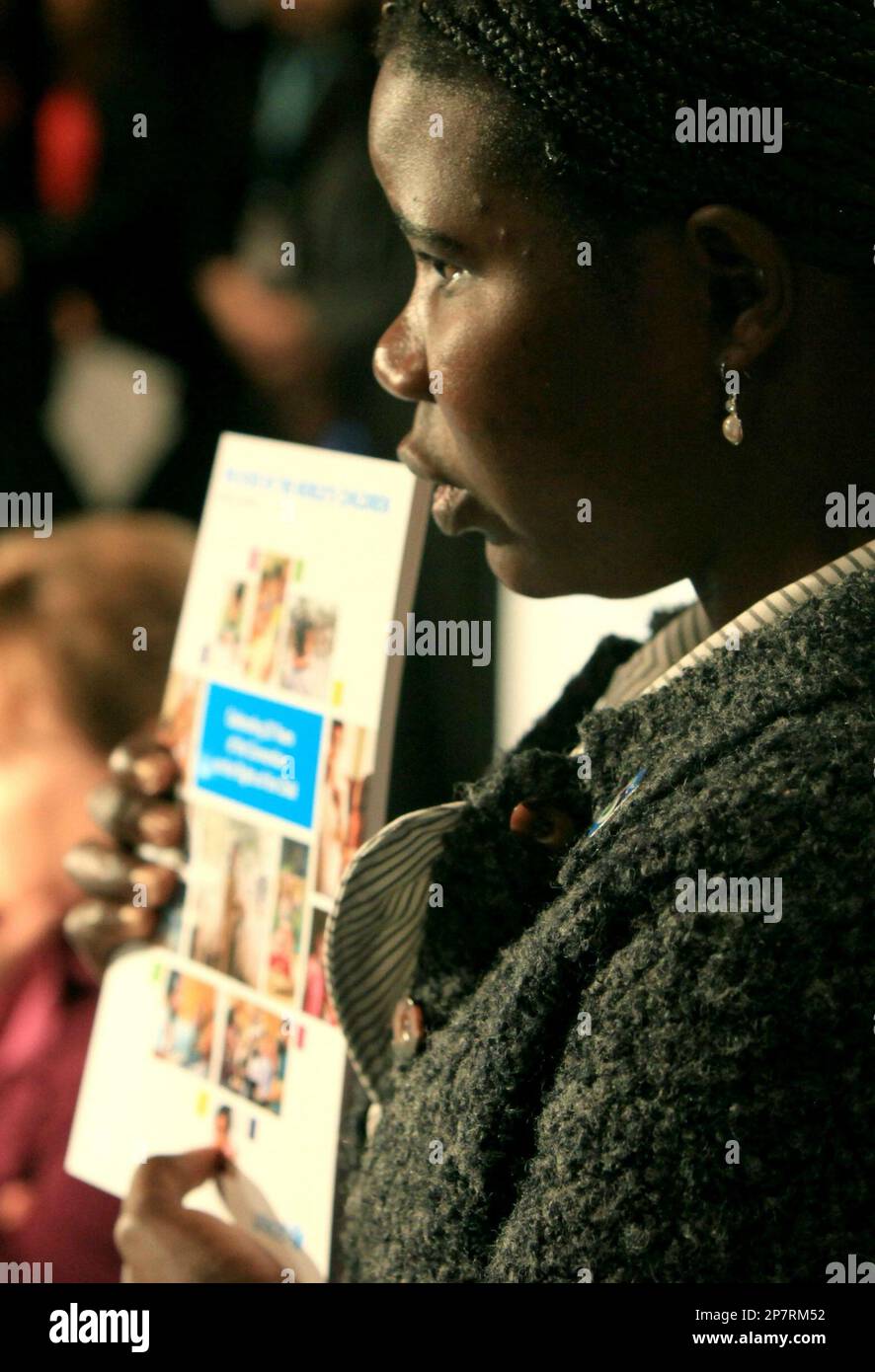 Grace Akallo, 29, a former child soldier in Uganda, holds a copy of a ...