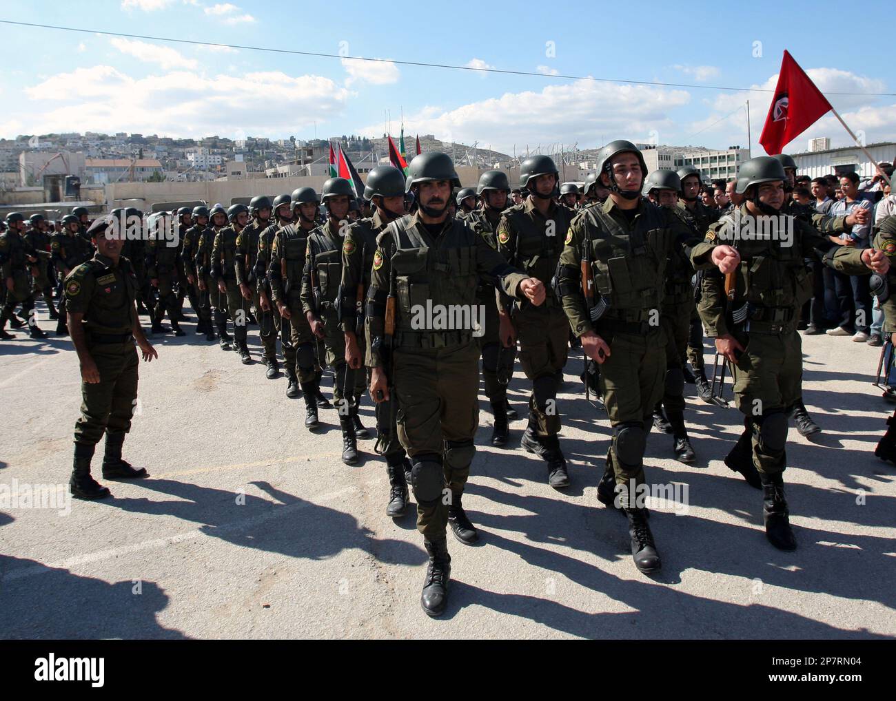 Palestinian security force officers, take part in a march marking the ...