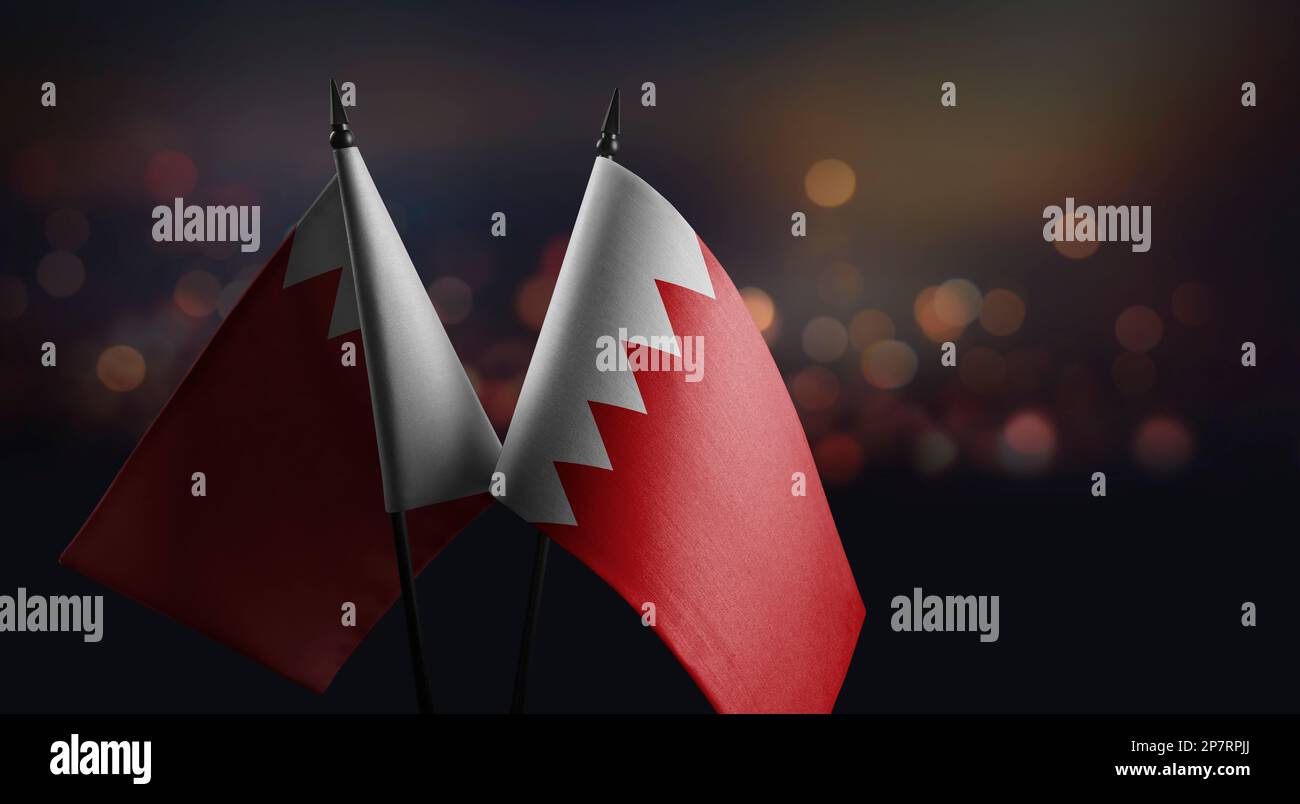 Small flags of the Bahrain on an abstract blurry background Stock Photo ...