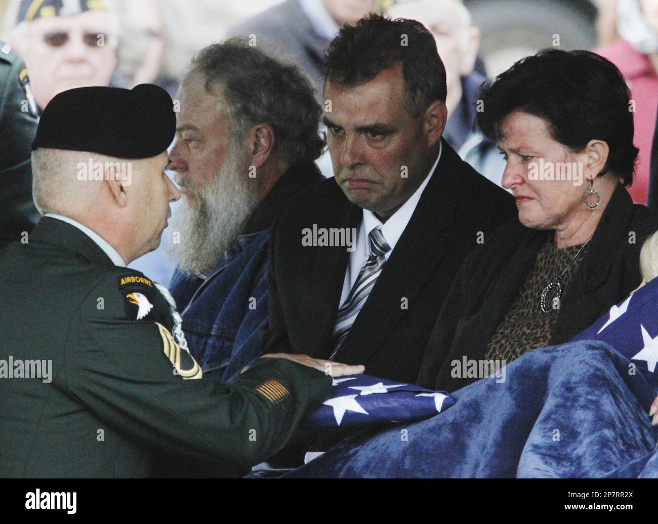 Sgt. 1st Class Allan Bair, left, presents a flag to Karen Nourse ...