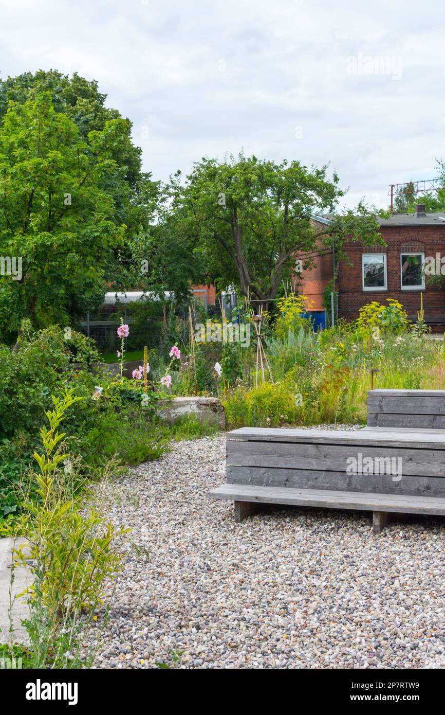A self-made wooden bench invites you to linger in the small wild ...