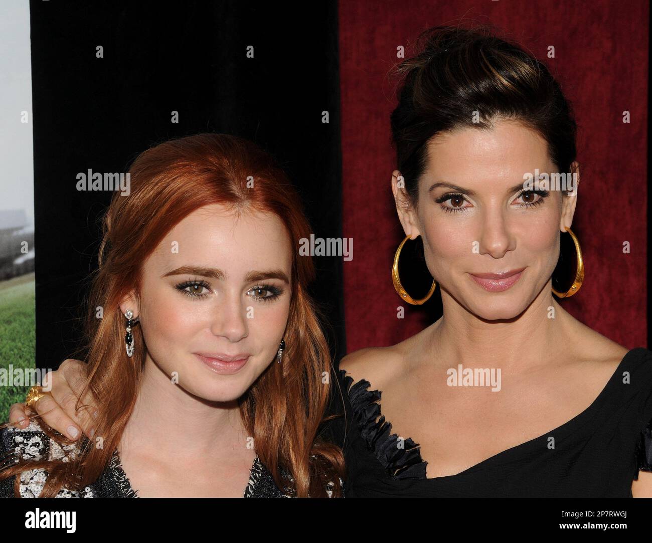 Actors Lily Collins, left, and Sandra Bullock attend the Warner Bros ...