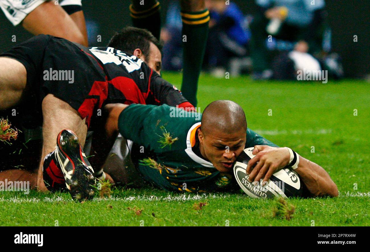 South Africa's Juan de Jongh, right, scores the opening try against ...