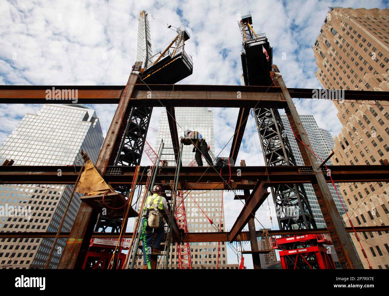 Ironworkers climb the rising steel above the fourth floor of One World ...
