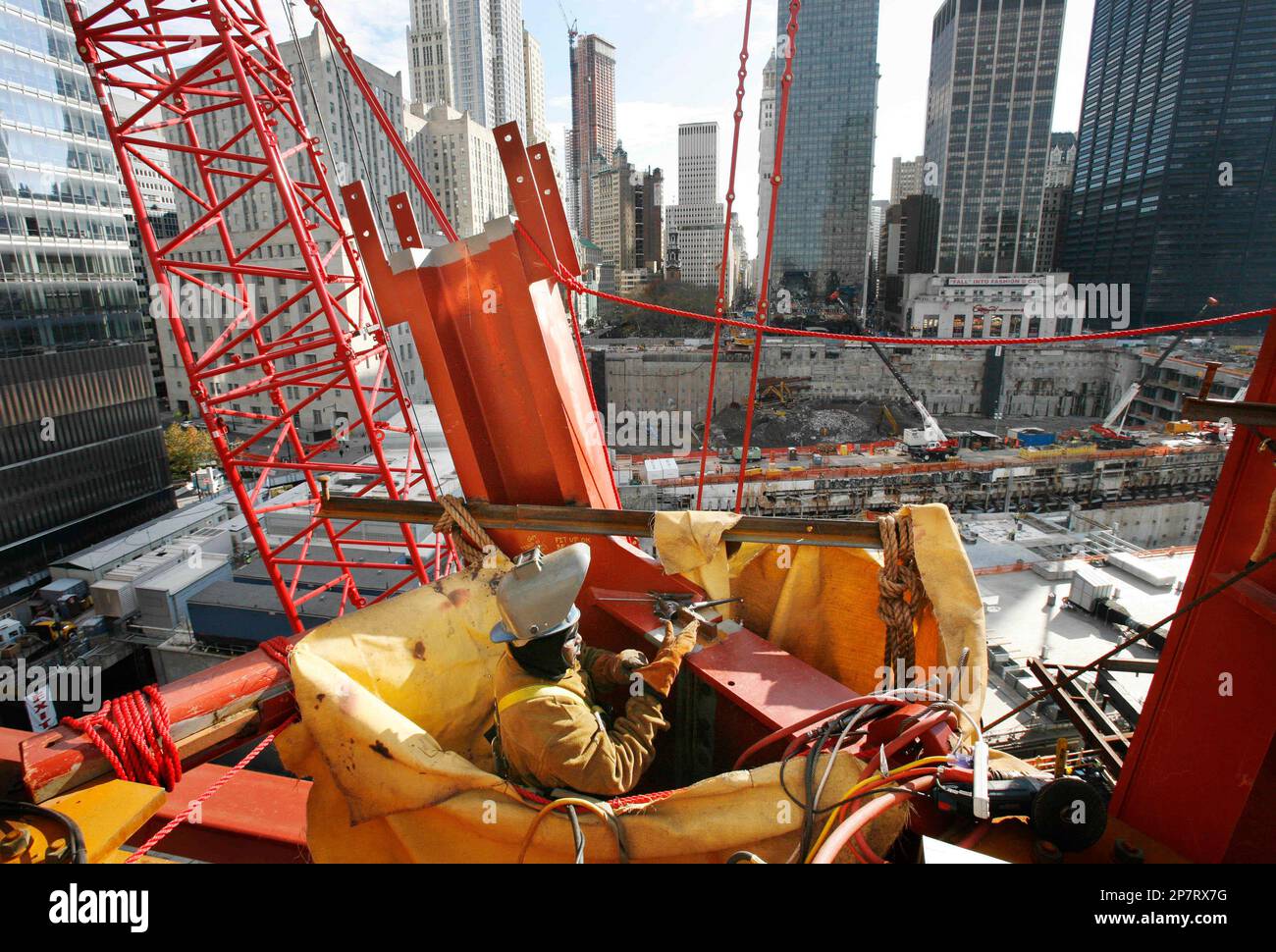 Ironworker Eon Mathieson prepares to connect a steel beam on the fourth ...