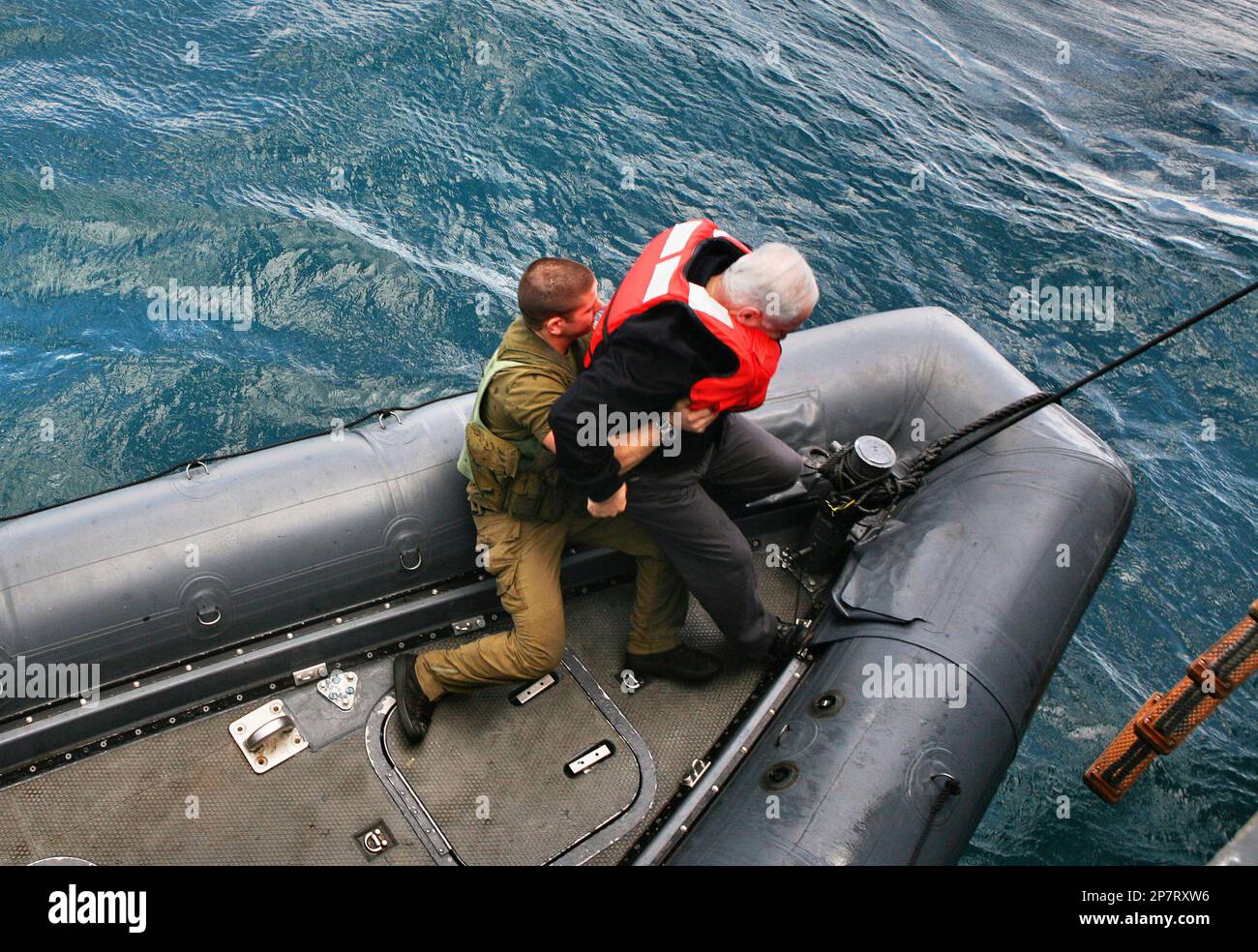 Israeli Prime Minister Benjamin Netanyahu, right, is assisted by a ...
