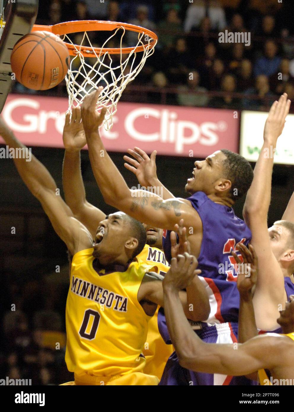 Stephen F. Austin's Orren Tims, center, tries for a shot around ...