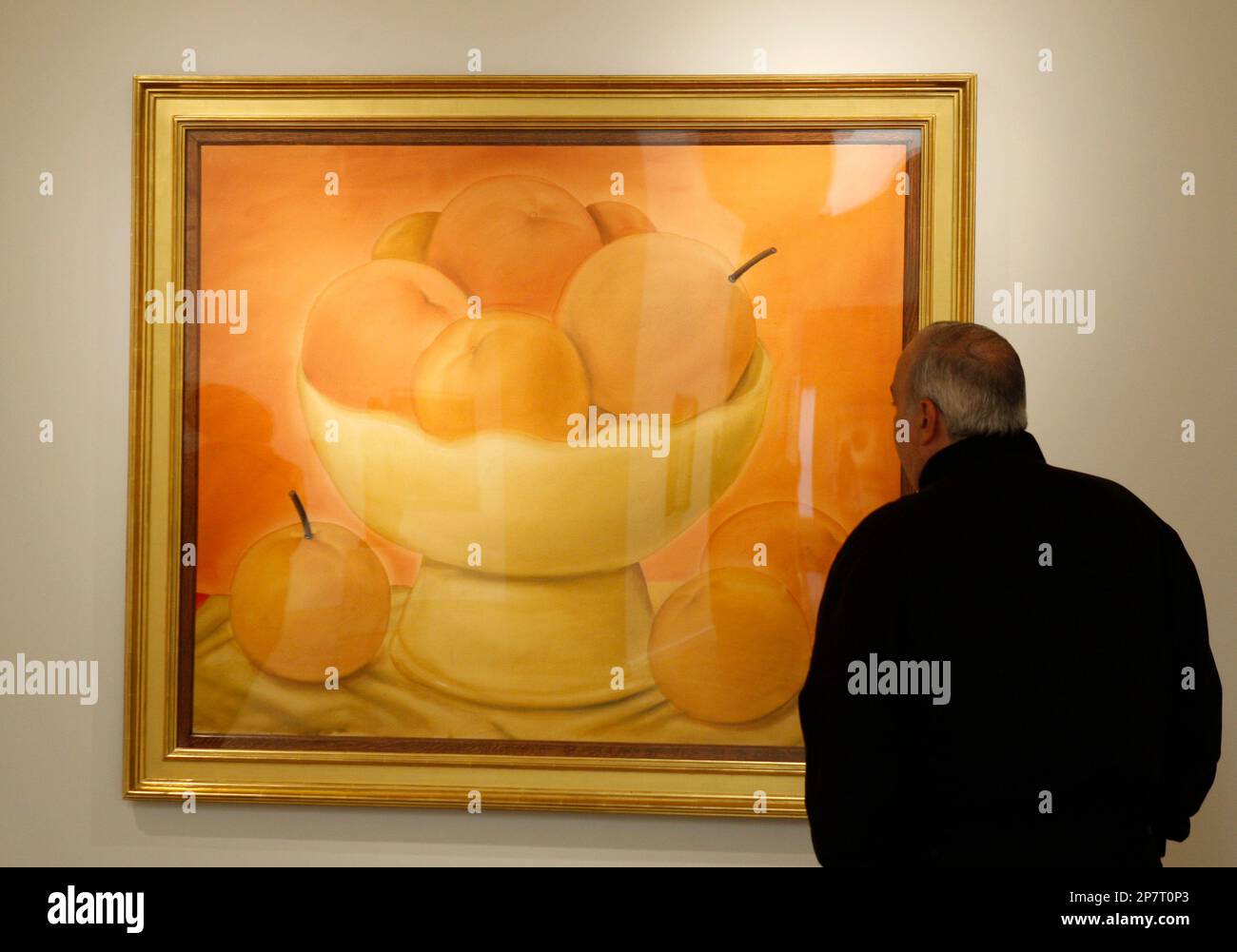 An art patron views Fernando Botero's "Oranges," on display at Sotheby ...