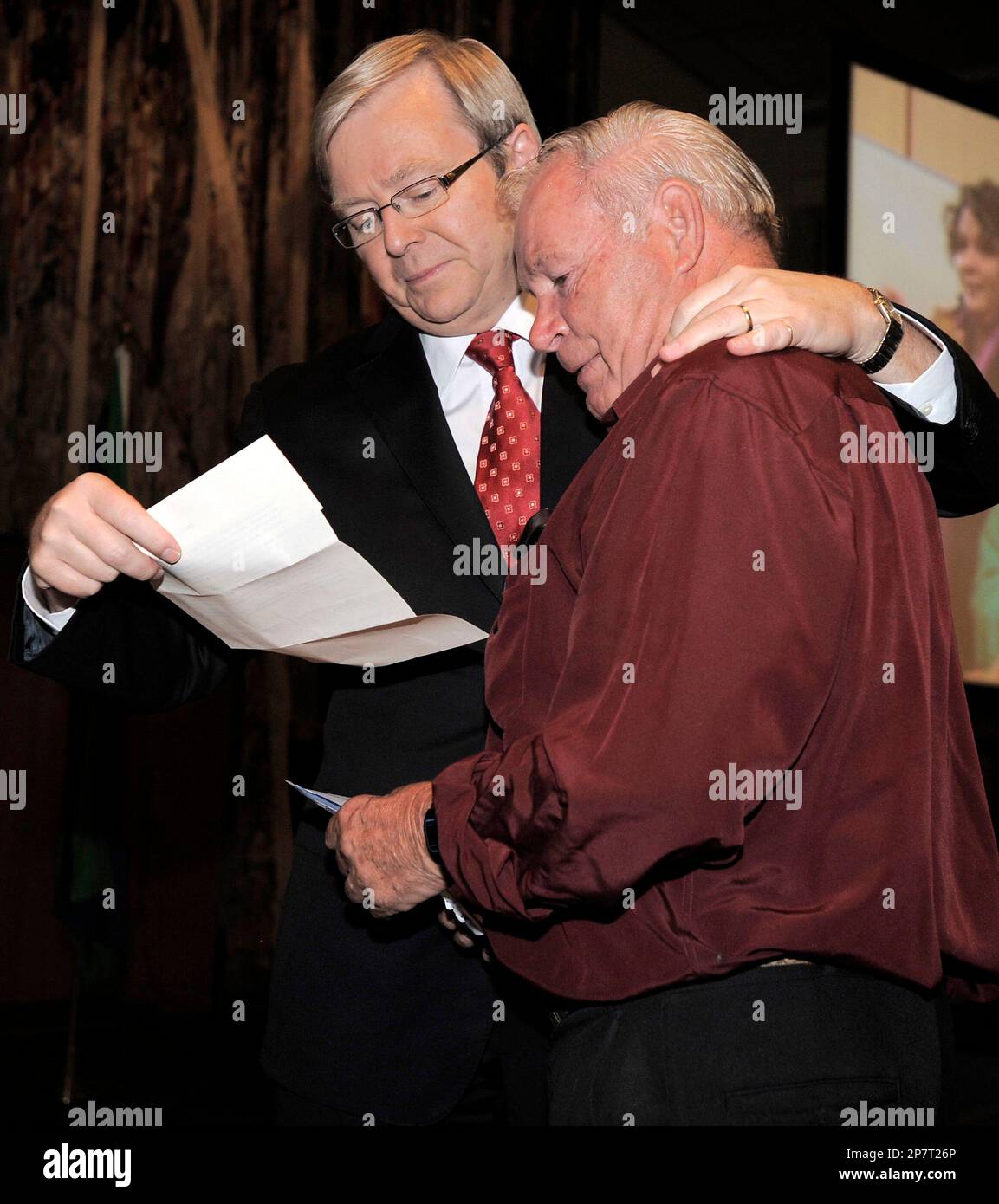 Australian Prime Minister Kevin Rudd, left, comforts a man attending a ...