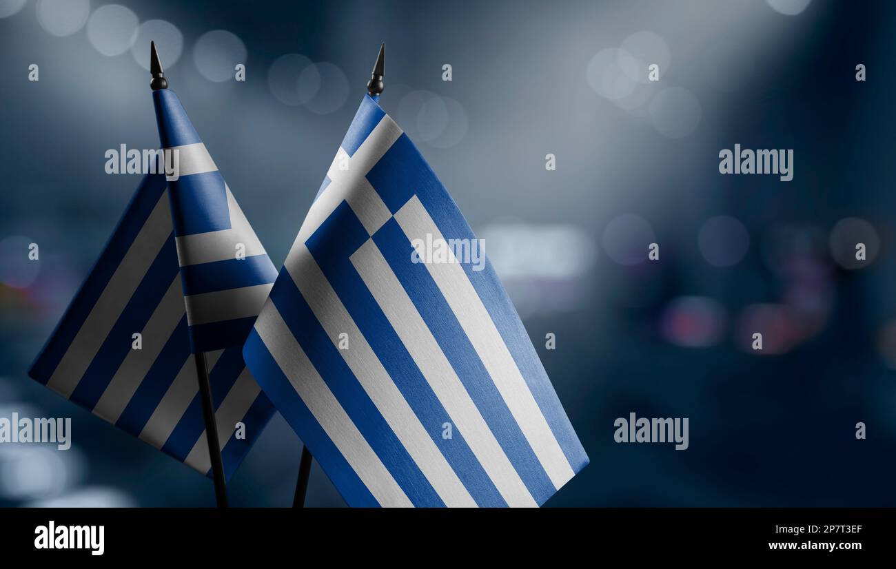 Small flags of the Greece on an abstract blurry background Stock Photo ...