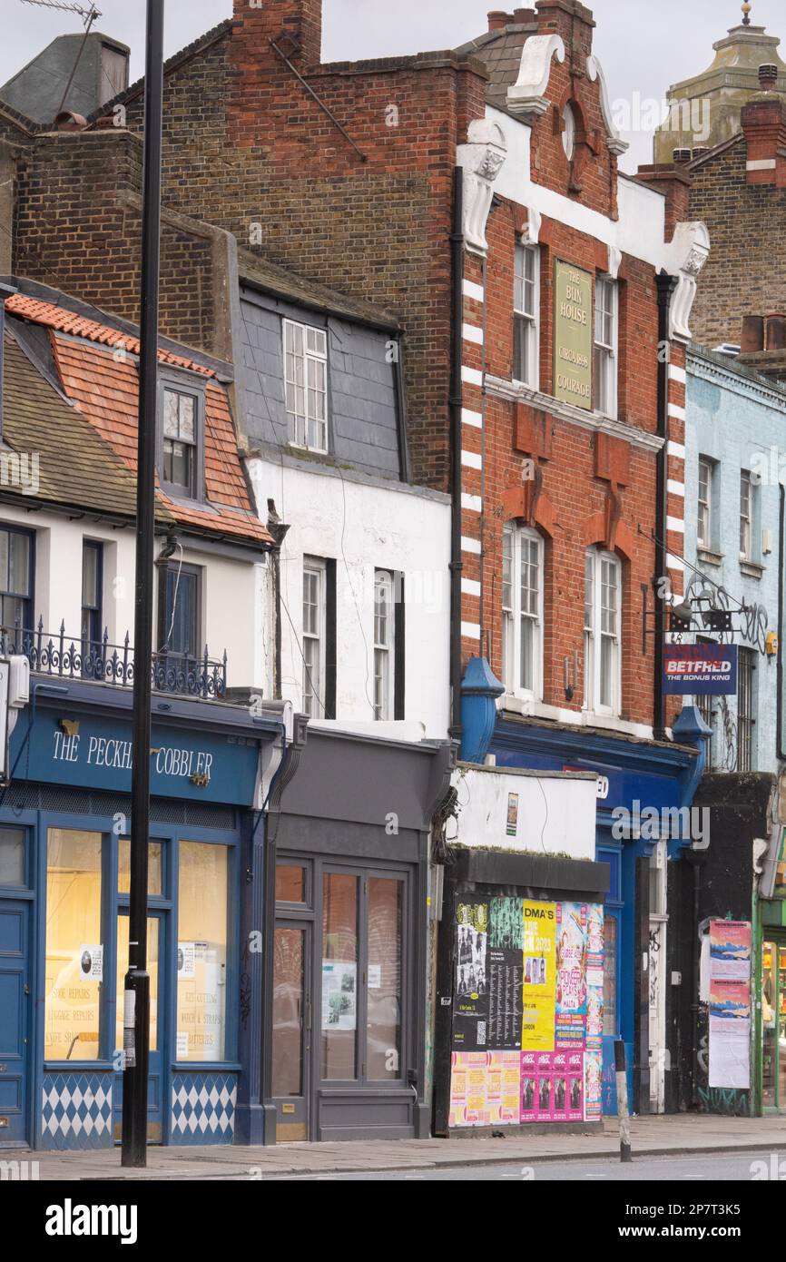 Shops and pubs line a street in Peckham, London, featuring the Bun ...