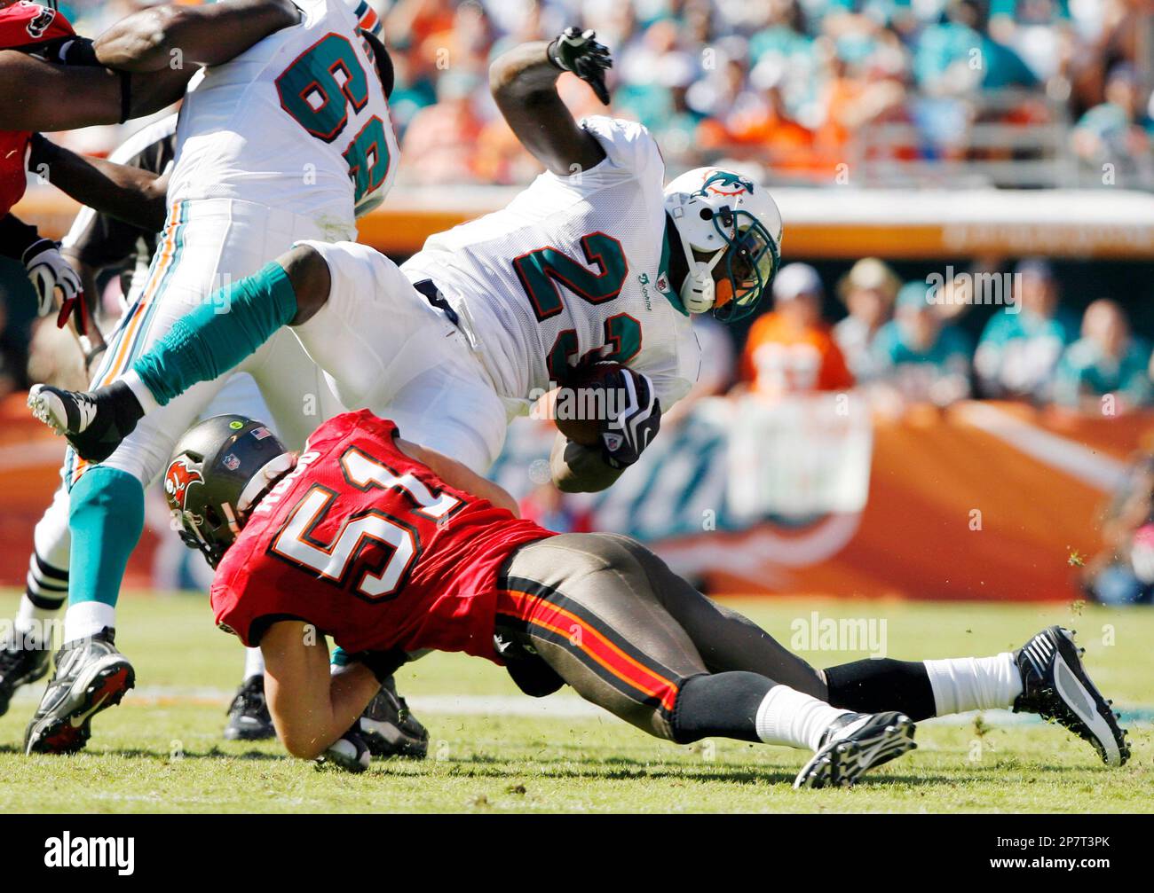 Miami Dolphins' Ronnie Brown (23) tackled by Tampa Bay Buccaneers ...
