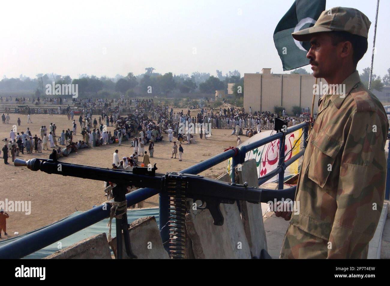 A Pakistani army soldier mans a post at a relief center, where ...