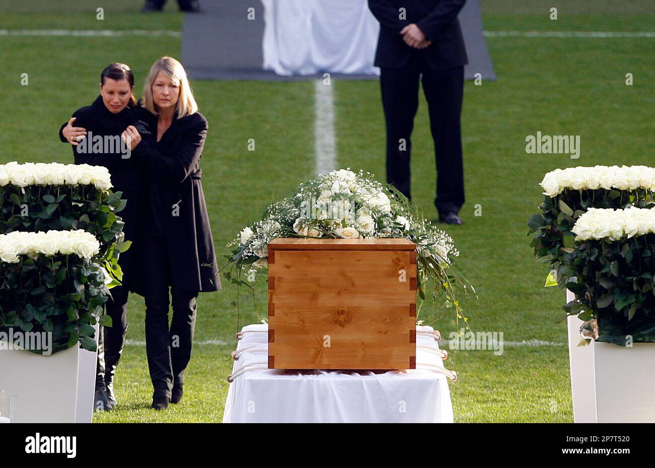 Enke' s wife Teresa, left, is comforted by an unidentified woman in ...