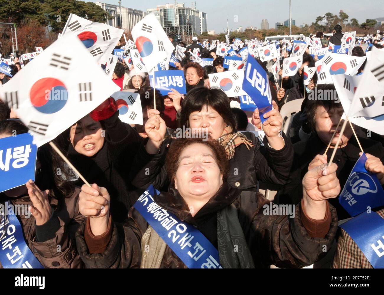 South Korean Christians with national flags pray during a special ...