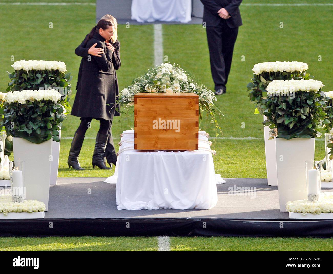 Enke' s wife Teresa, left, is comforted by an unidentified woman in ...