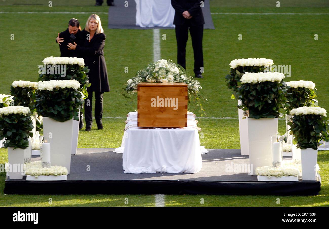 Enke' s wife Teresa, left, is comforted by an unidentified woman in ...